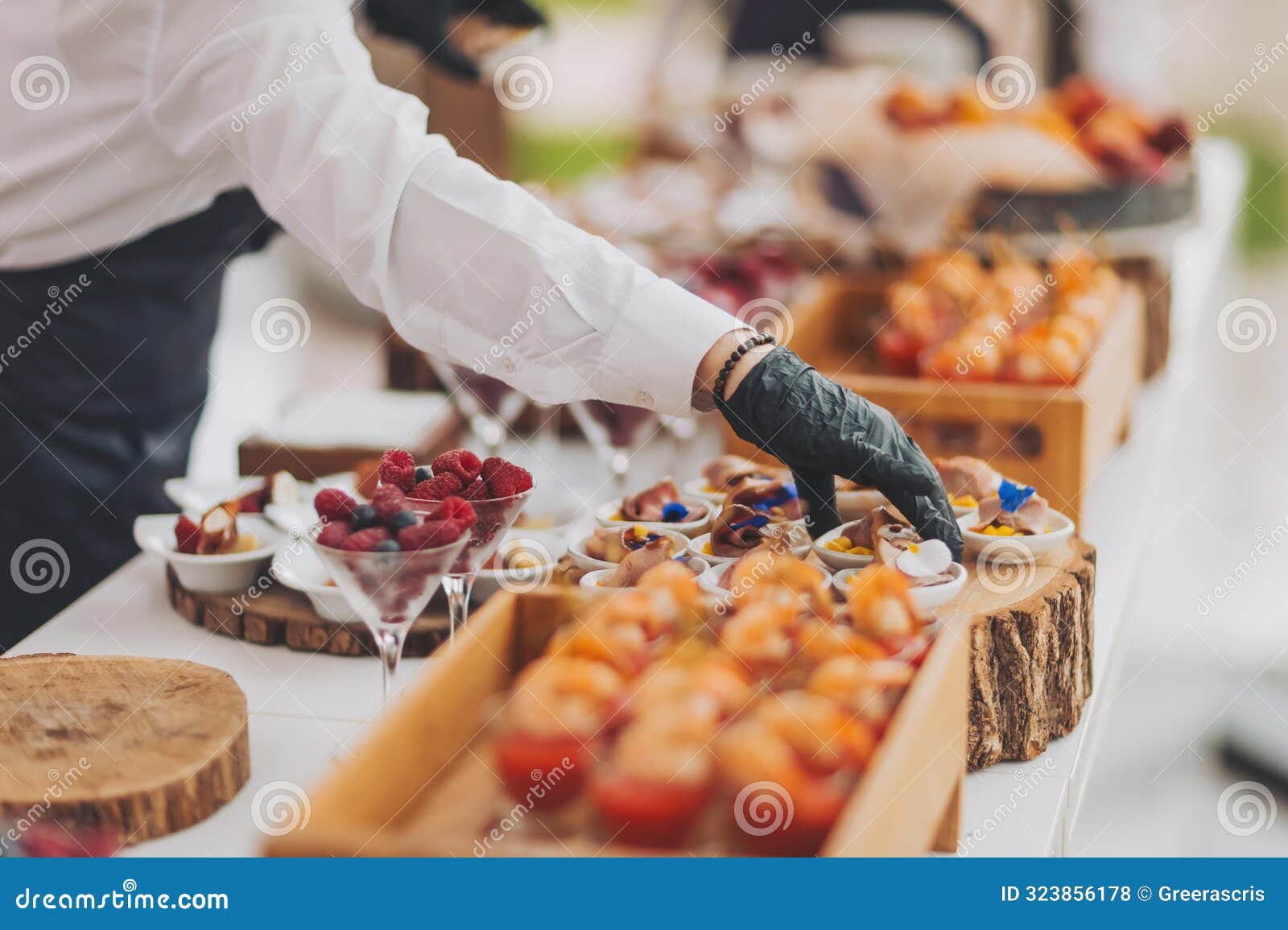 Hands of a Waiter Prepare Food for a Buffet Table in a Restaurant ...
