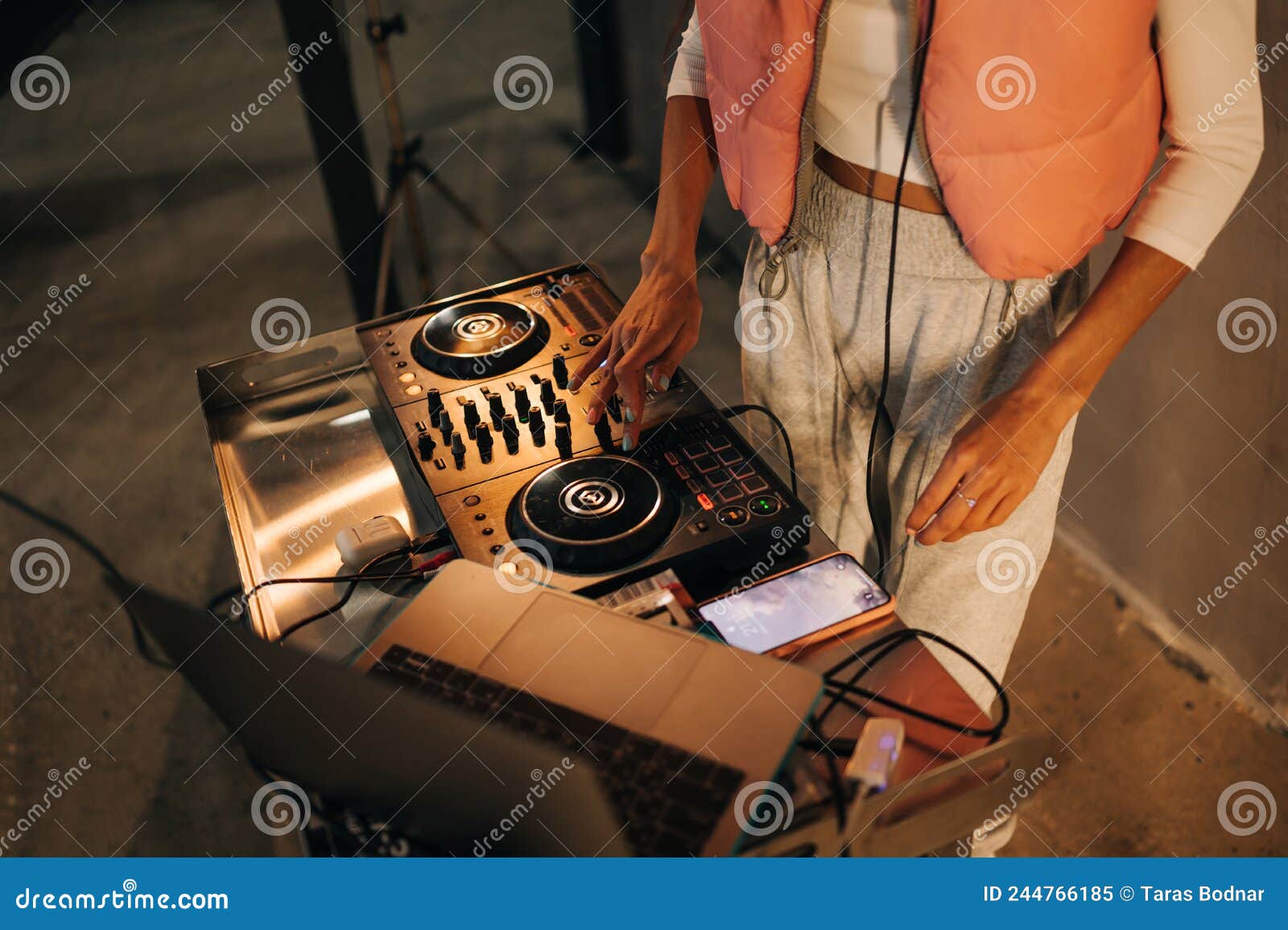 Hands of a Woman DJ Playing Music on the Controller, Erecting Tracks ...