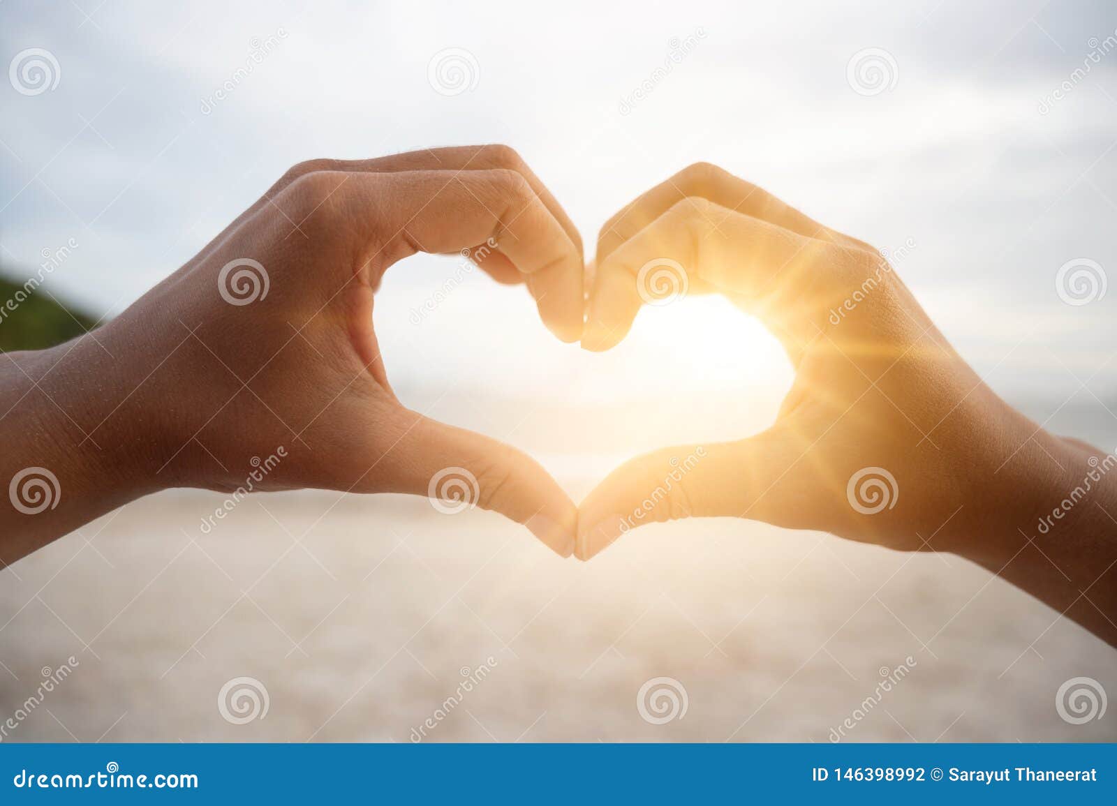 The Hands of Women and Men are the Heart Shape with the Sun Light ...