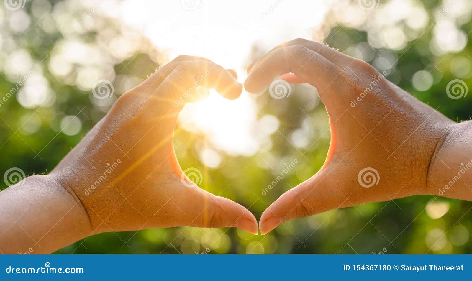 The Hands of Women and Men are the Heart Shape with the Sun Light ...