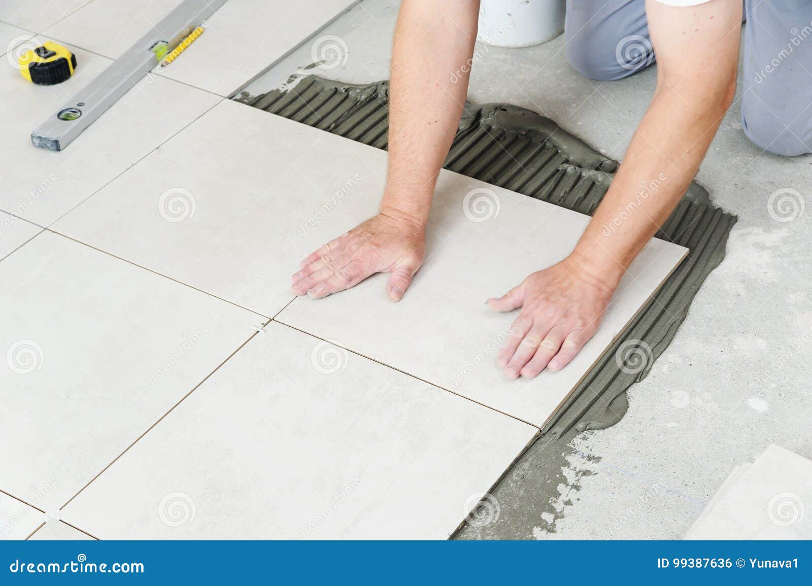 Laying Ceramic Tiles. stock photo. Image of tiler, glue - 99387636