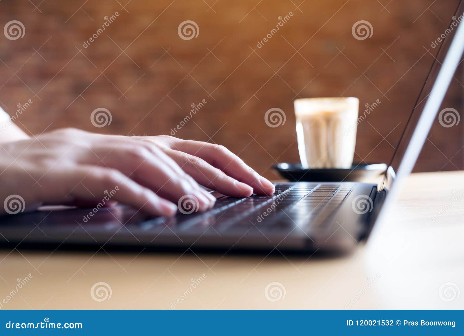 Hands Working and Typing on Laptop Keyboard with Coffee Cup on Table in ...