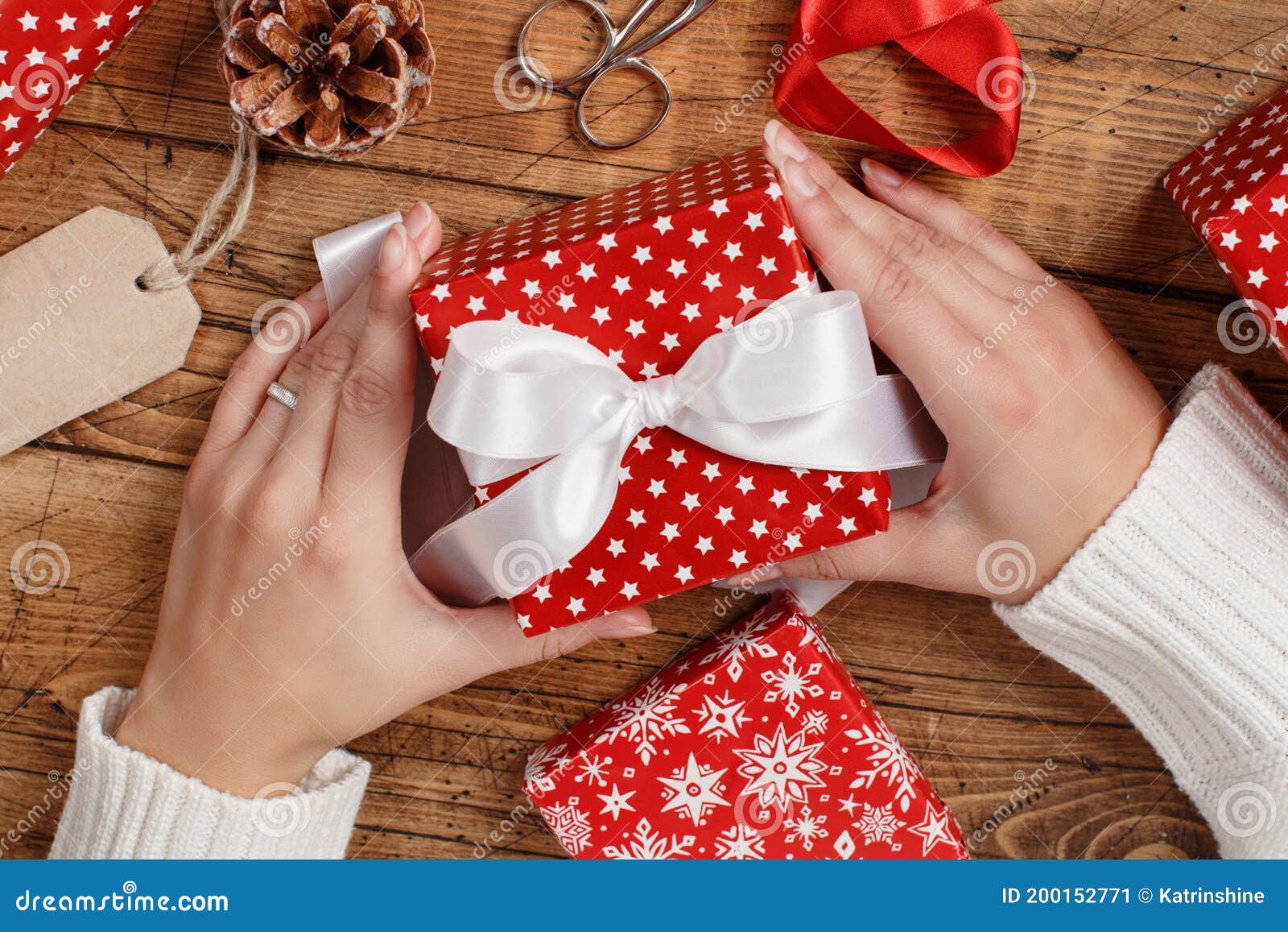 Hands with wrapped present stock image. Image of table - 200152771