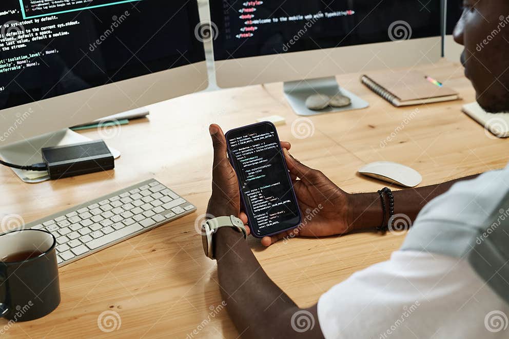 Hands of Young Black Man Scrolling through Codes in Smartphone by ...