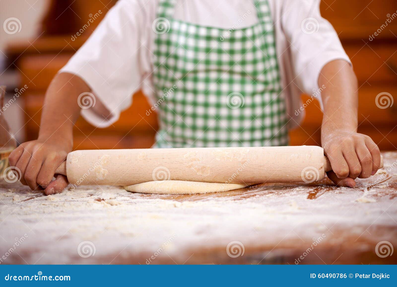 Hands of a Young Boy Who Pulls the Dough in the Kitchen Stock Photo ...