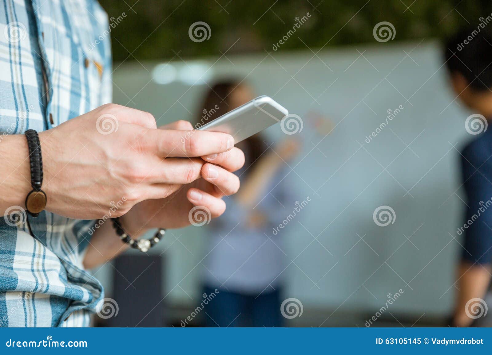 Hands of Young Guy Using Smartphone while His Colleagues Working Stock ...