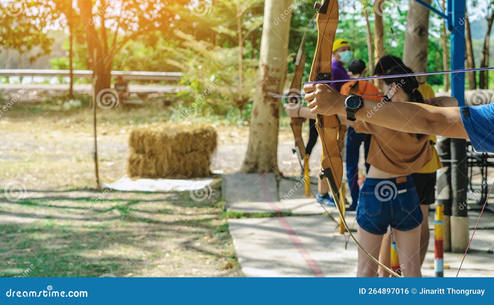 Hands of Young Man Aims Archery Bow and Arrow To Colorful Target in ...