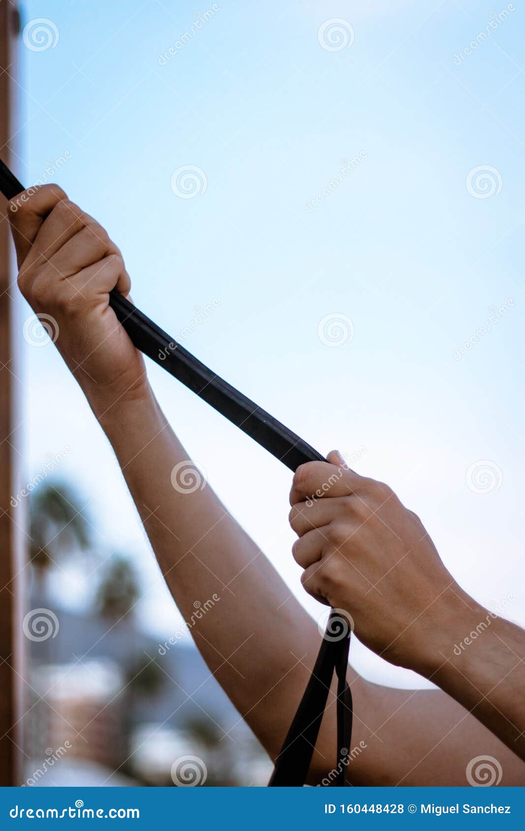 Hands of Young Man Holding a Black Elastic Band Stock Photo - Image of ...