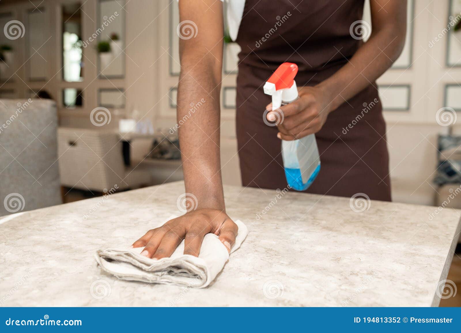 Hands of Young Waiter with Detergent and Duster Cleaning Table after ...