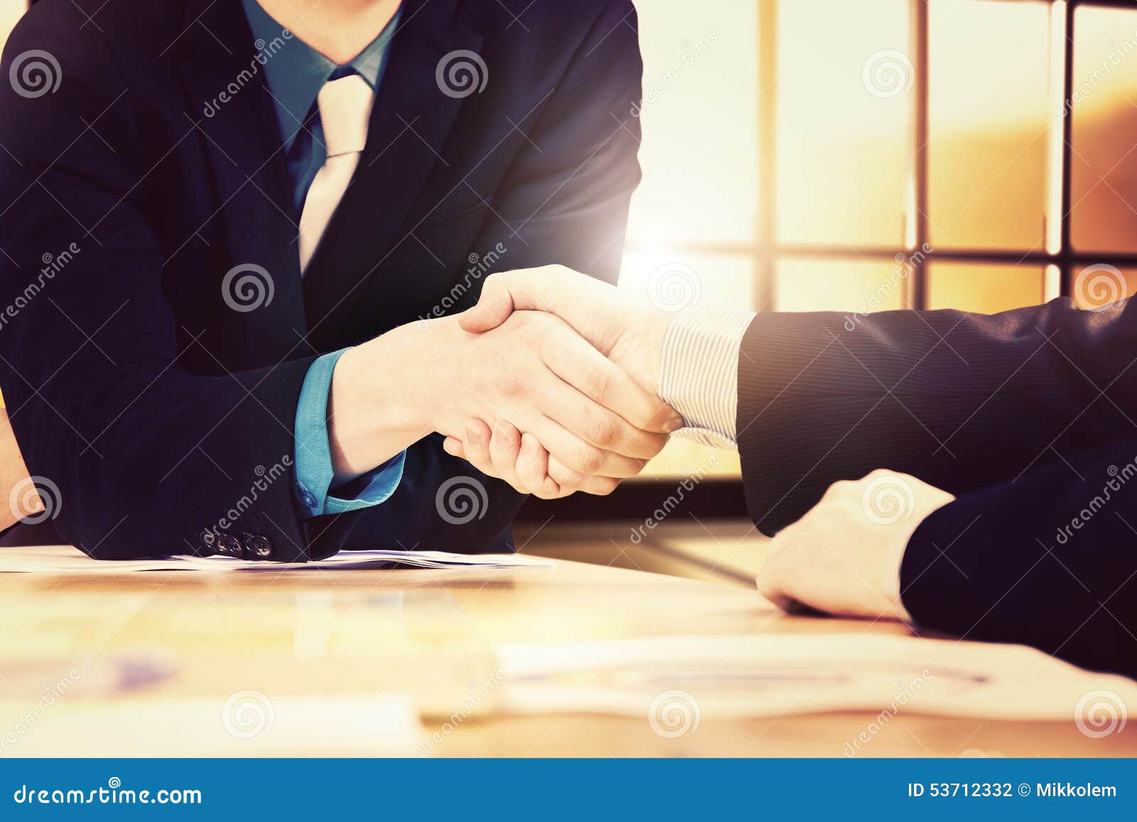 Handshake Above Table with Bright Sunlight Stock Photo - Image of ...