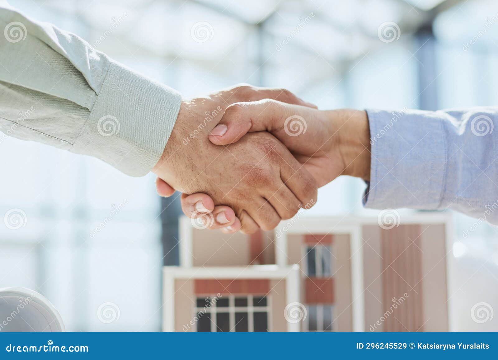 Handshake Against the Background of a Model of a House Under ...