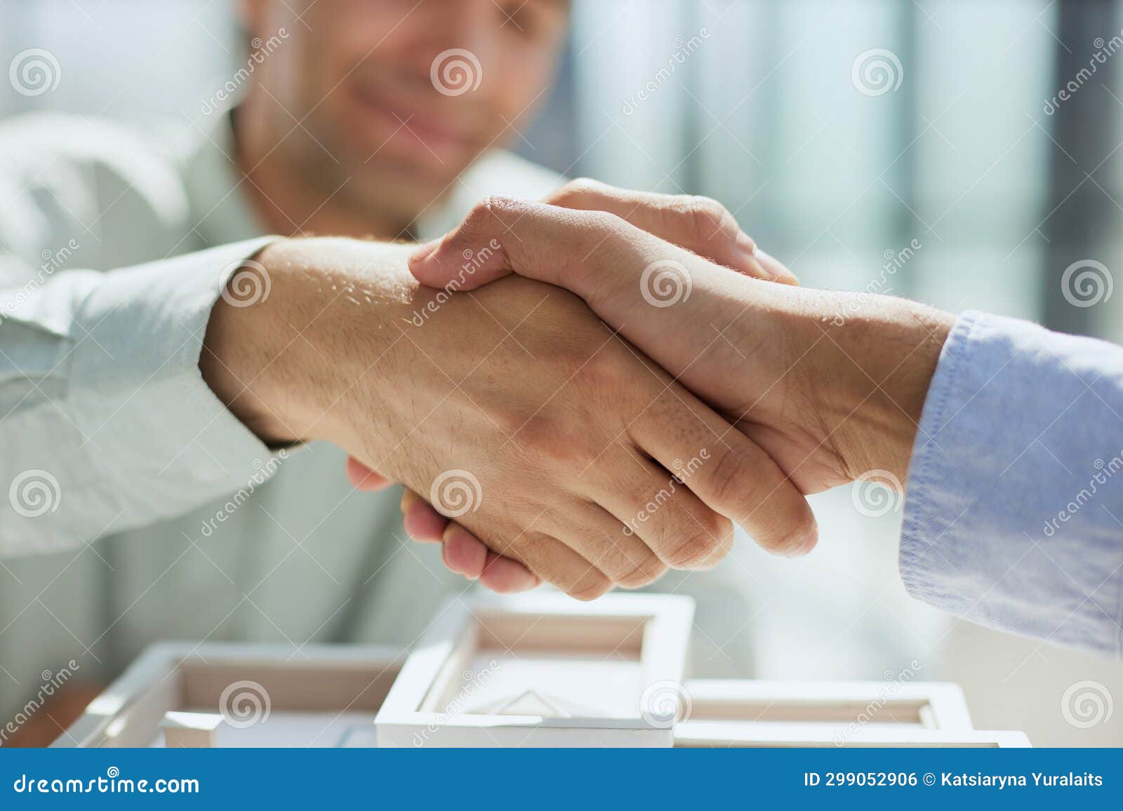Handshake Against the Background of a Model of a House Under ...