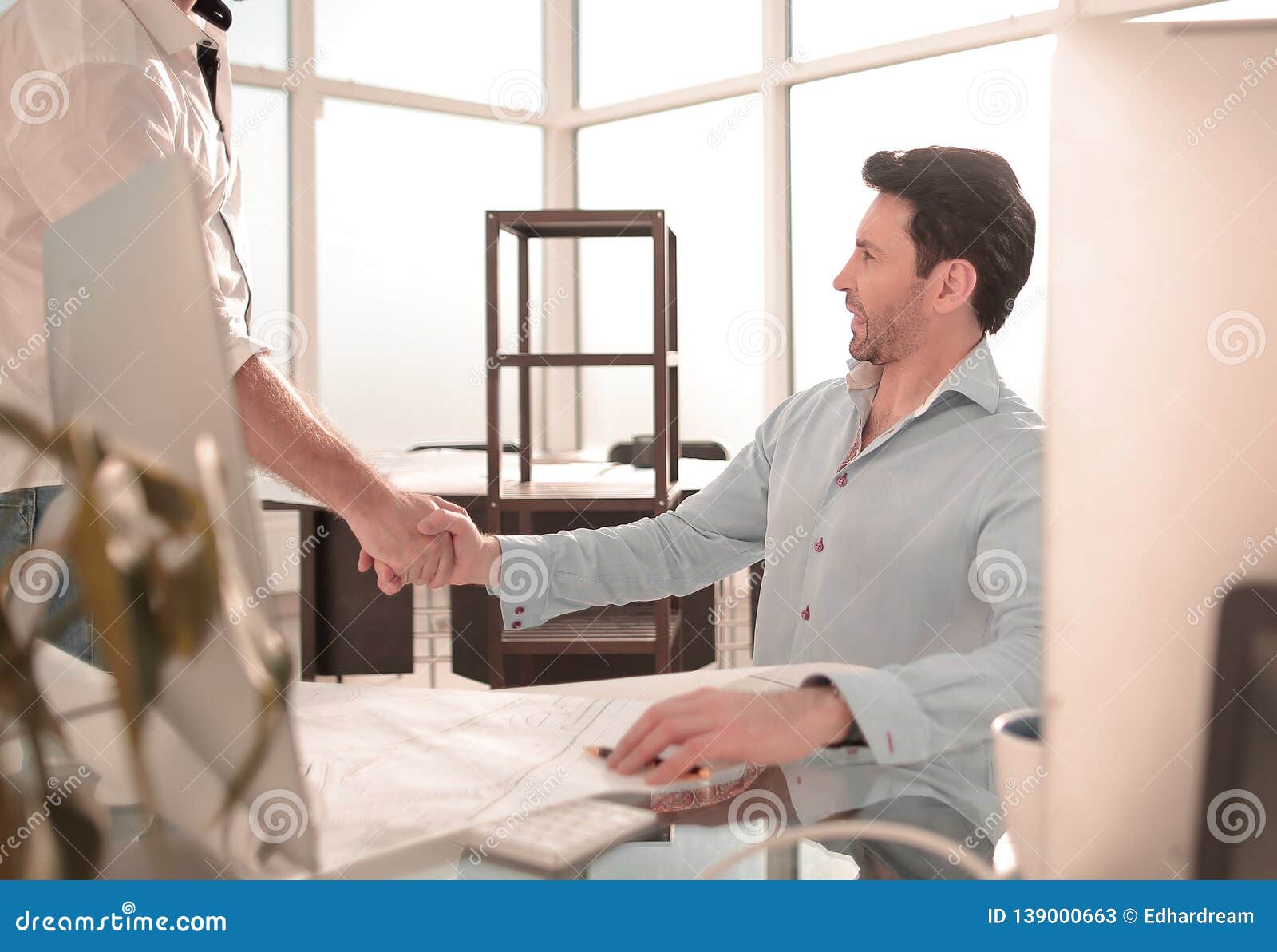 Handshake between Agent and Customer in a Modern Office Stock Image ...