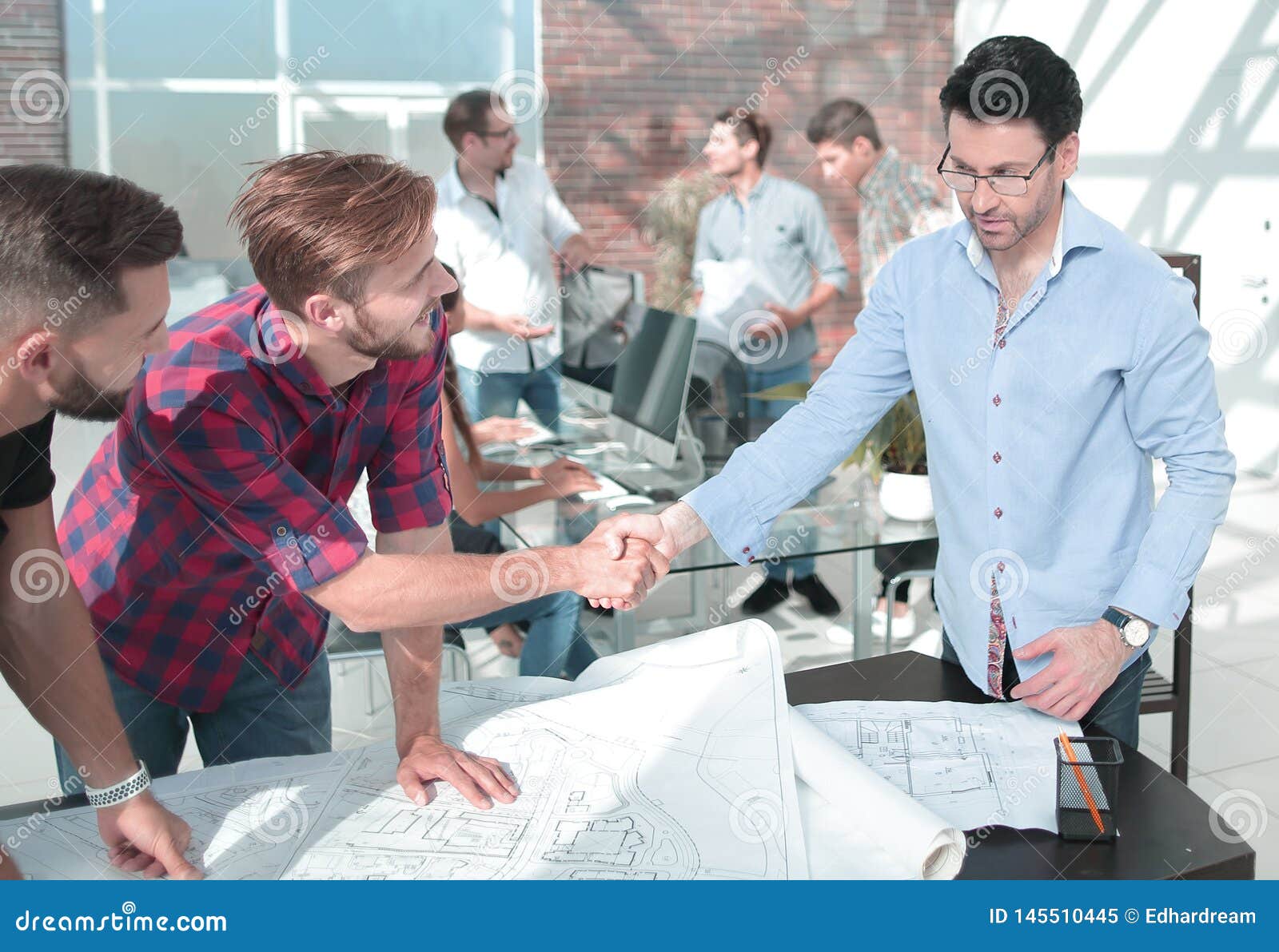 Handshake of the Architect and Contractor Over a Work Des Stock Image ...
