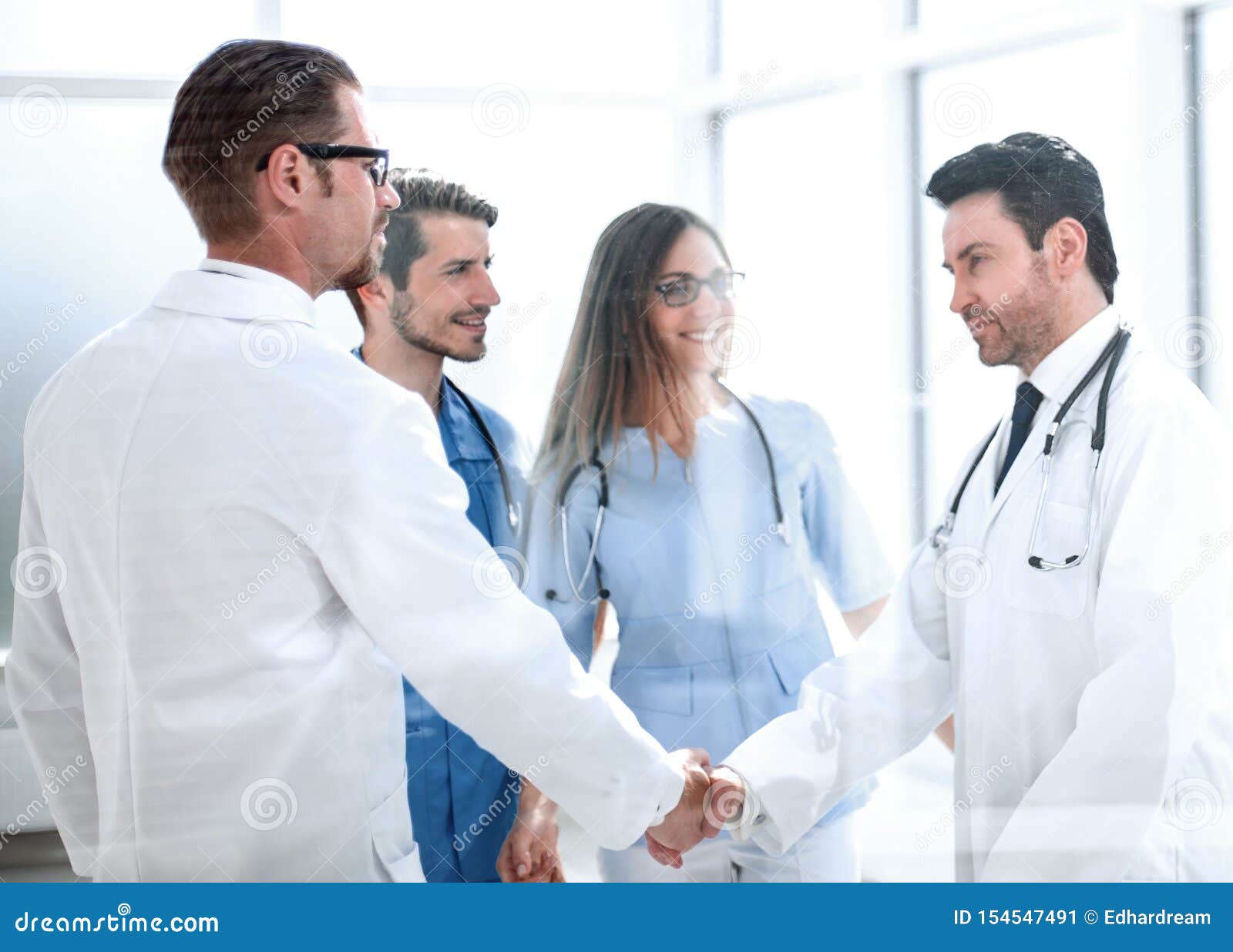 Handshake Colleagues in the Hospital Corridor Stock Image - Image of ...