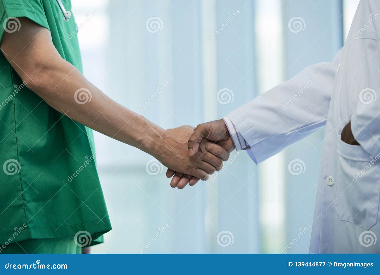 Handshake of doctors stock image. Image of unity, hall - 139444877
