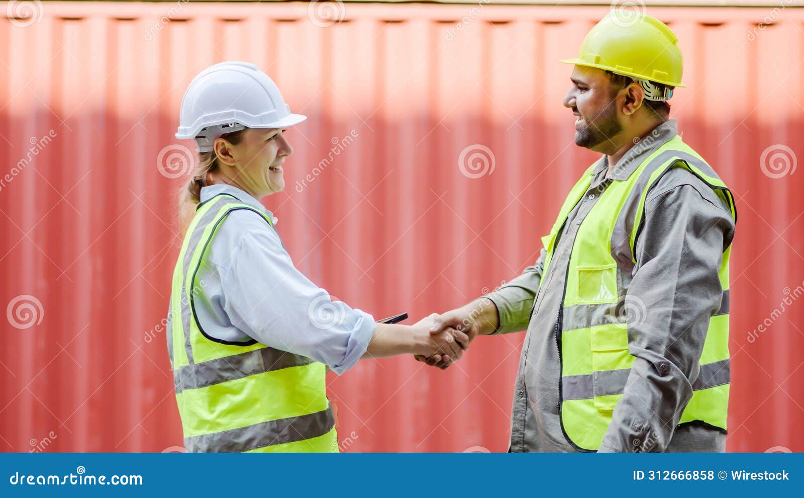 Two People Shaking Hands in Front of a Shipping Container Building ...