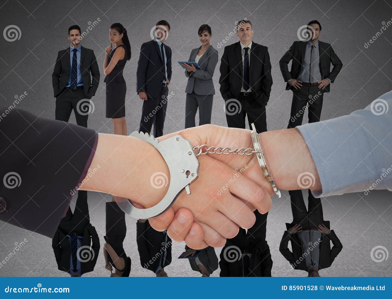 Handshake with Handcuffs in Front of Business People in Grey Room Stock ...