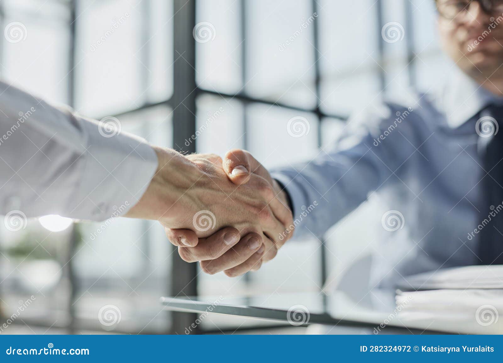 Handshake of Manager and Client Sitting at Table in Modern Office Stock ...