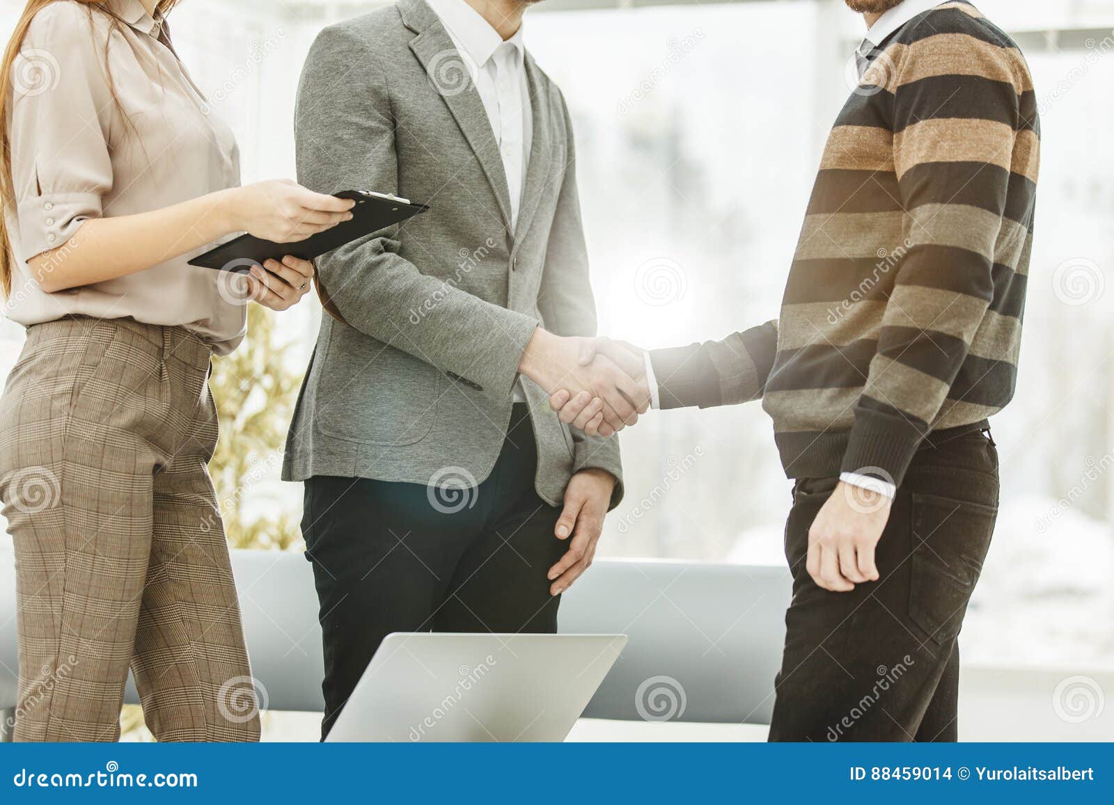 Handshake of a Manager and a Customer on the Background of the Office ...
