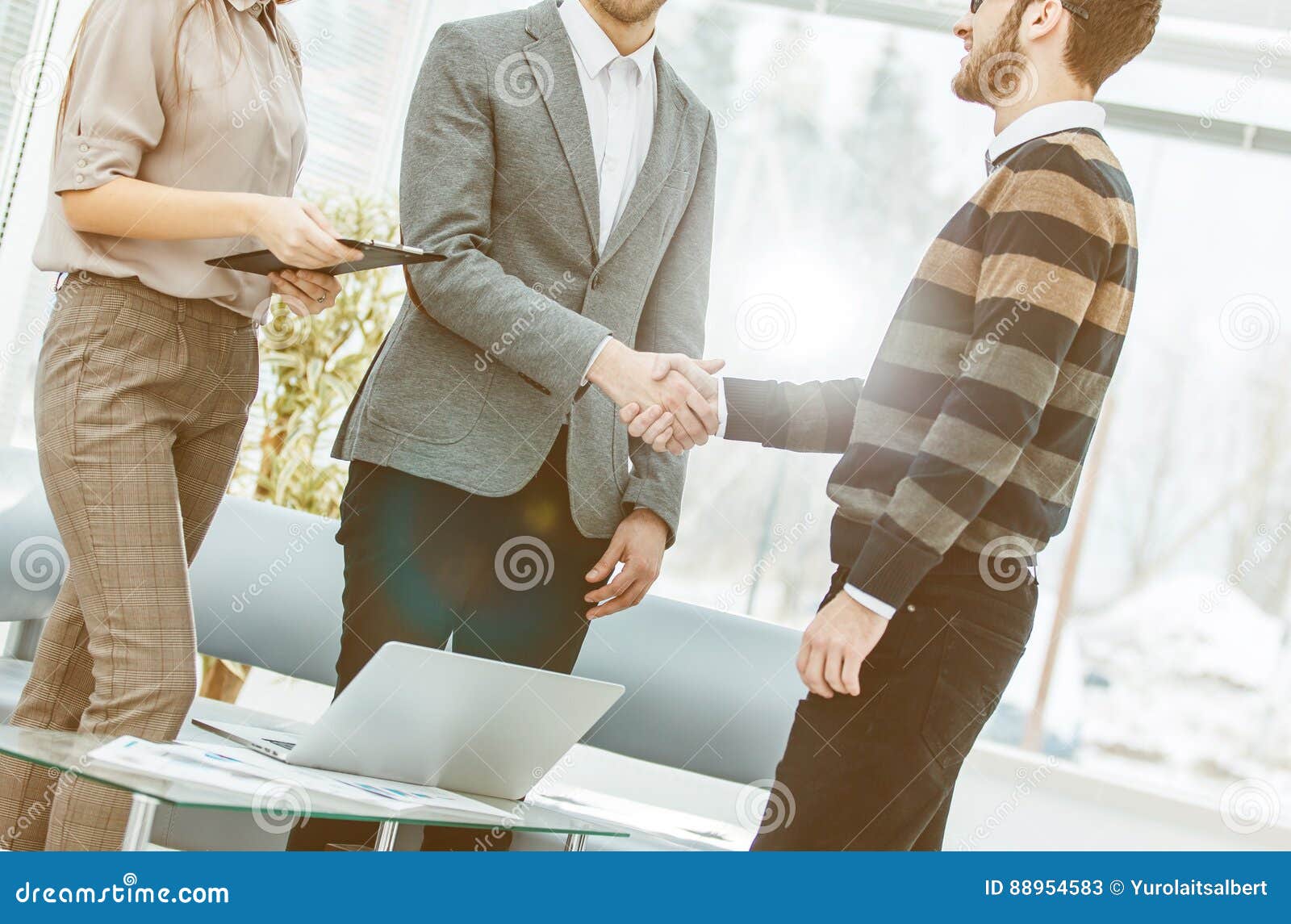 Handshake of a Manager and a Customer on the Background of the Office ...