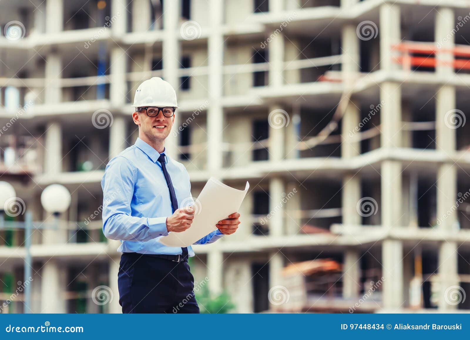 Handsom Construction Engineer at the Construction Site Looking at the ...