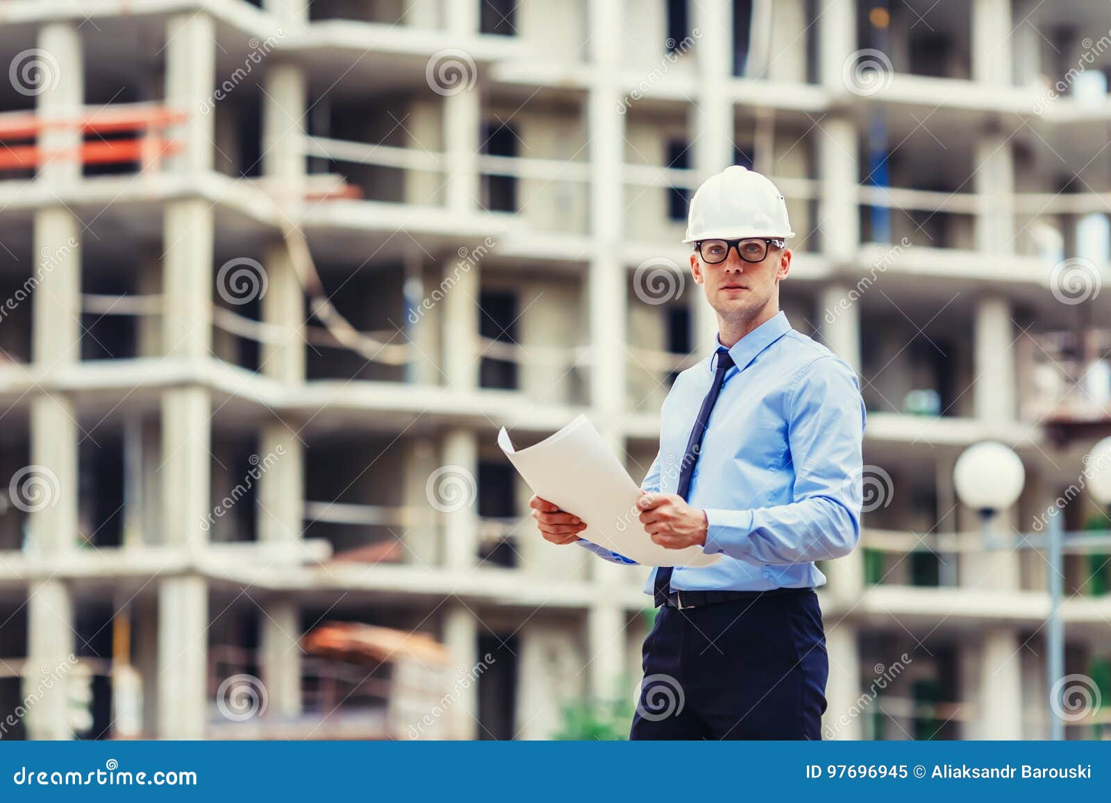 Handsom Construction Engineer at the Construction Site Looking at the ...