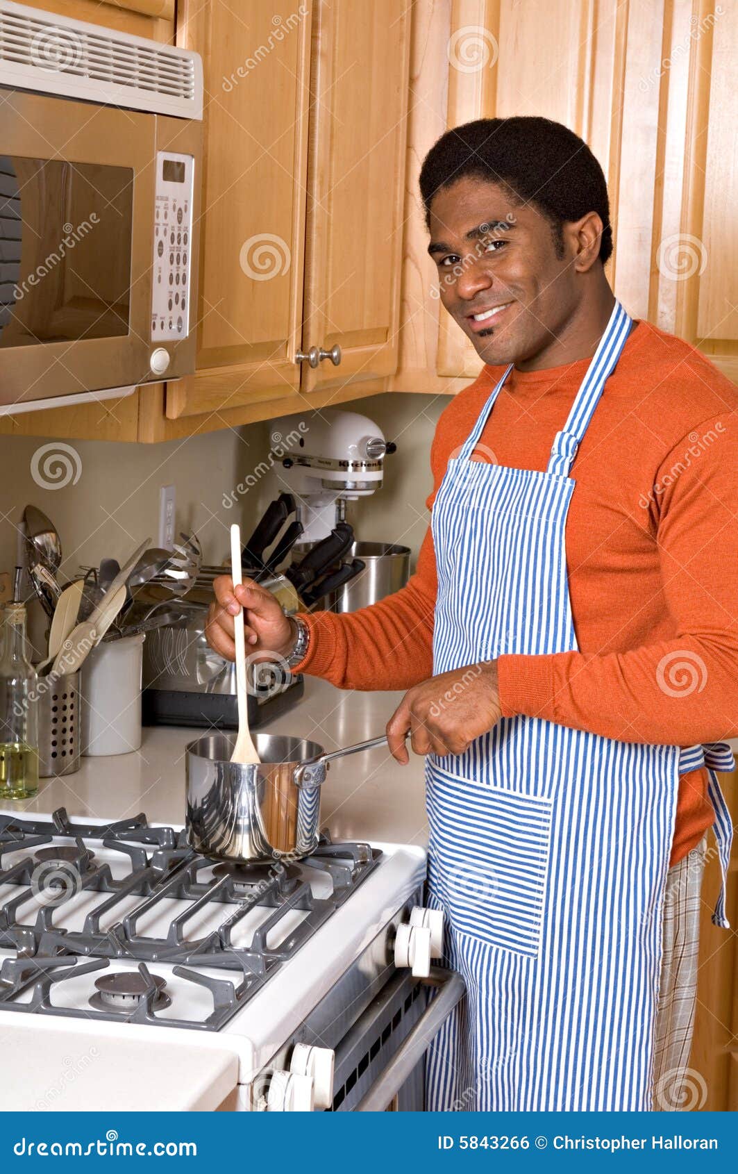 Handsome African-American Man Cooks in Kitchen Stock Photo - Image of ...