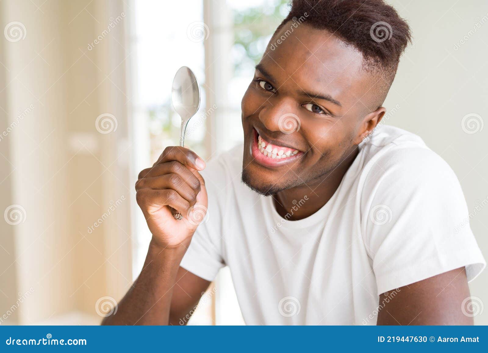 Handsome African Man Holding Silver Spoon Smiling Stock Photo - Image ...