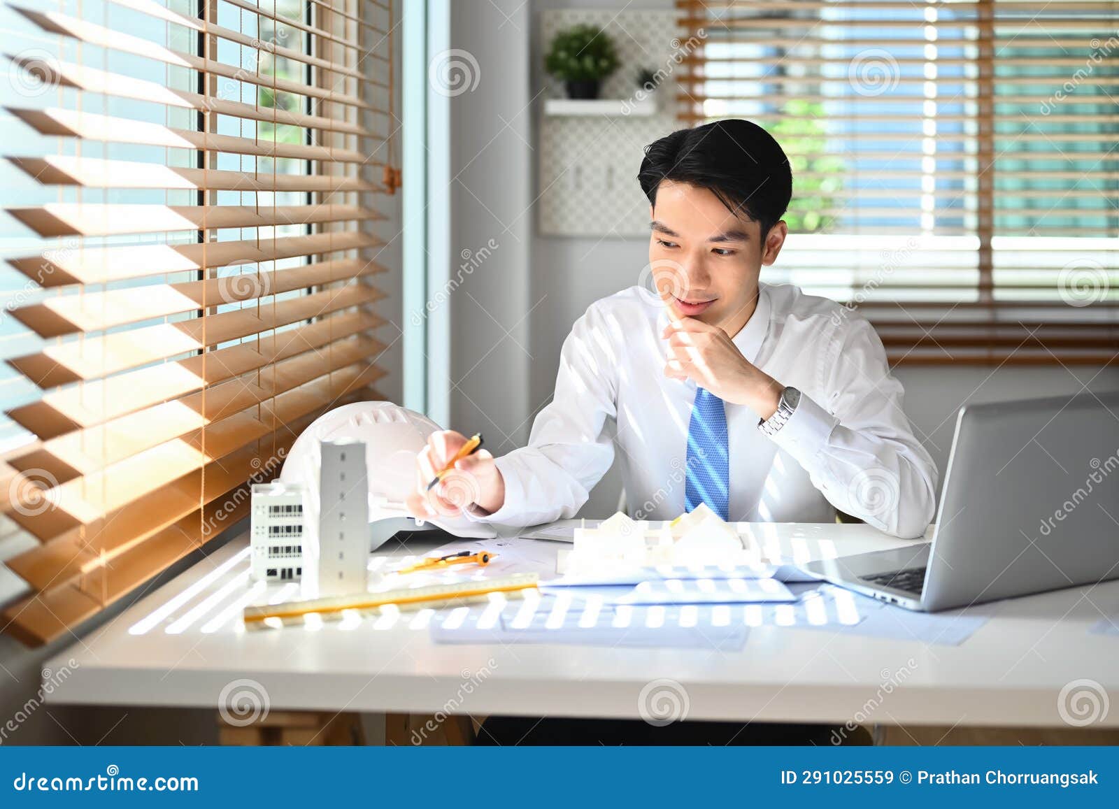 Handsome Asian Male Architect Working on New Building Model and Using ...