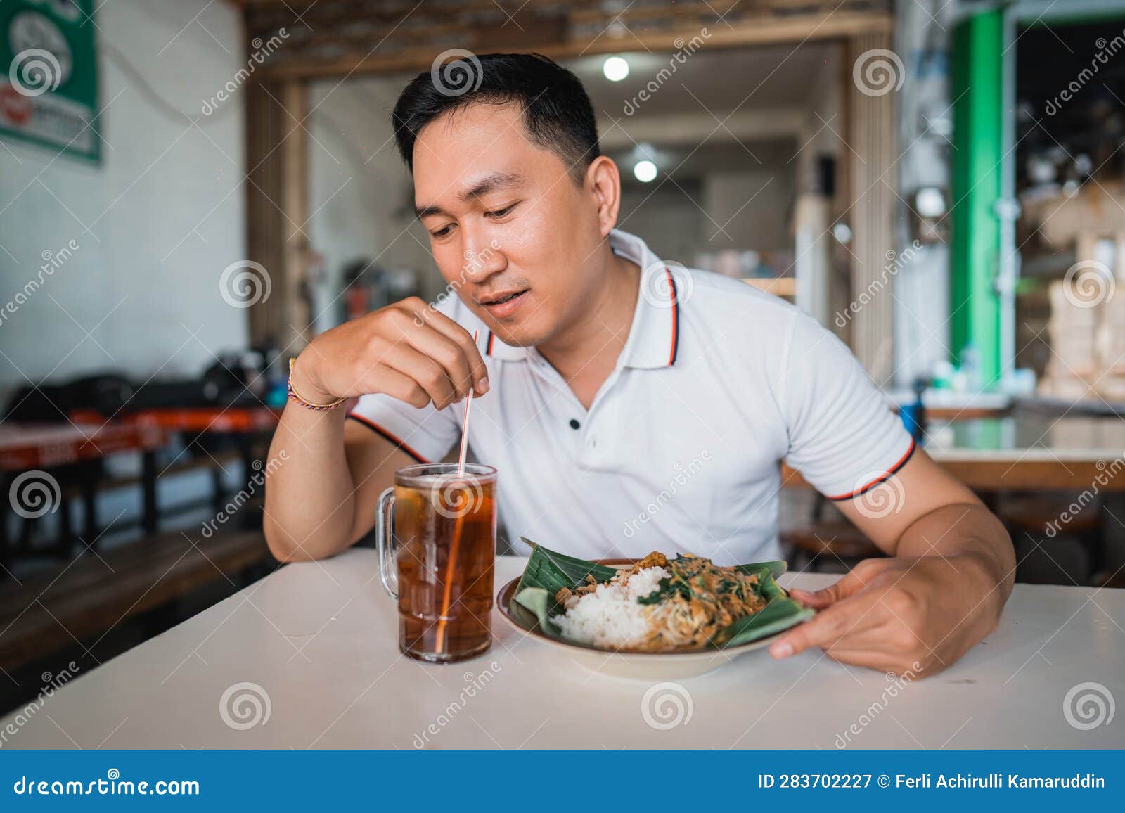 Handsome Asian Man Drinking Tea Using a Straw while Lunch Stock Image ...