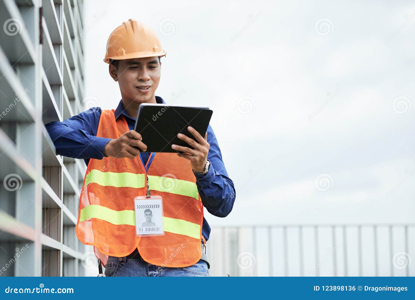Asian Engineer Using Tablet Near Wall Stock Photo - Image of ...