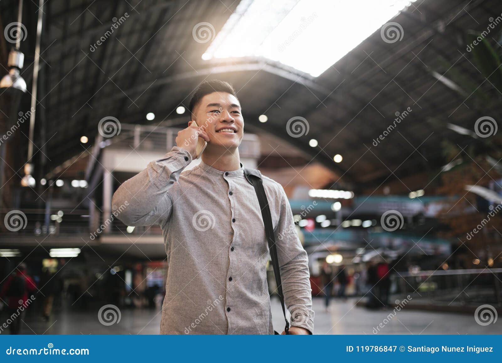 Handsome Asian Man Using Mobile in the Train Station. Stock Image ...