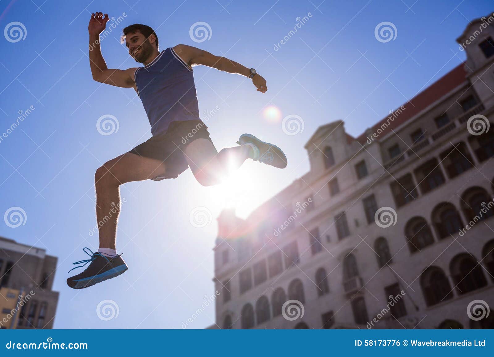 Handsome Athlete Leaping in Front of Building Stock Photo - Image of ...