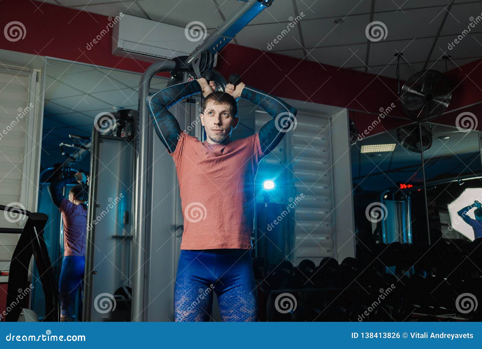 Handsome Athletic Man Trains Triceps on the Block in the Gym. Stock ...