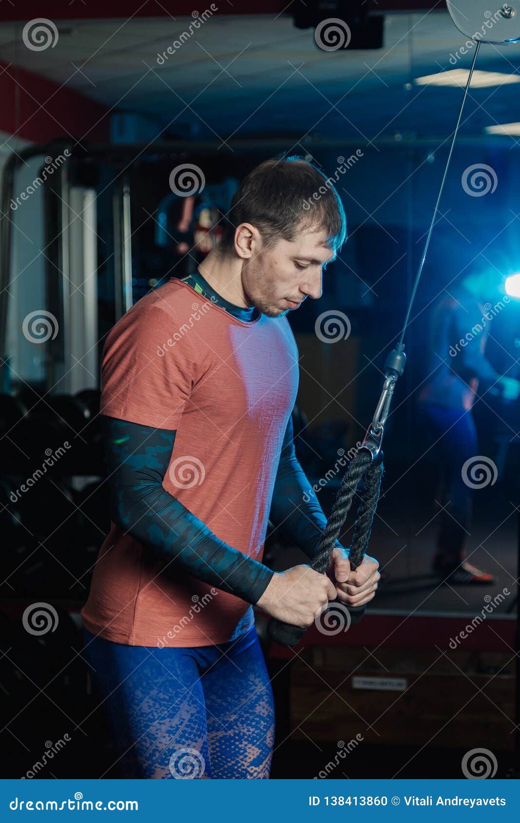 Handsome Athletic Man Trains Triceps on the Block in the Gym. Stock ...