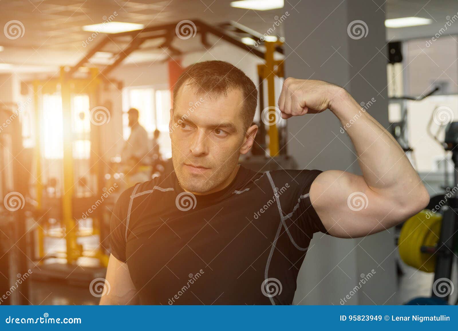 Handsome Athletic Young Man Showing His Biceps Posing in Gym Stock ...