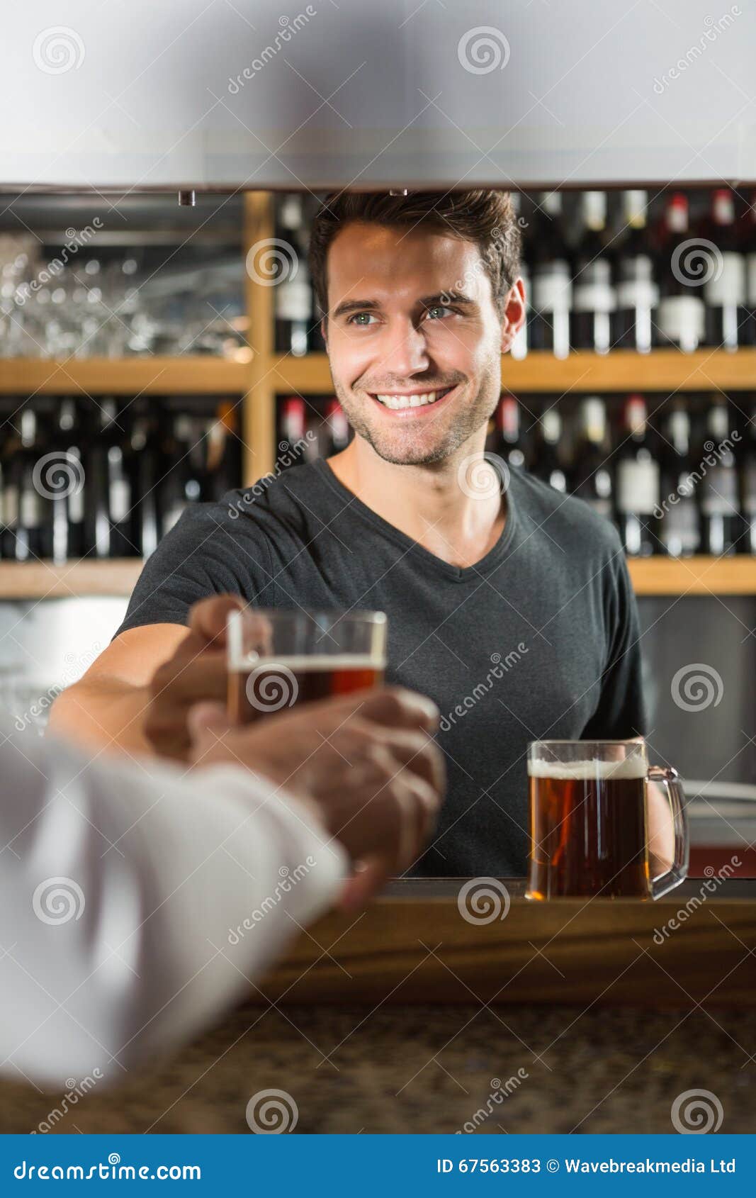 Handsome Bar Tender Giving a Pint To Customer Stock Image - Image of ...