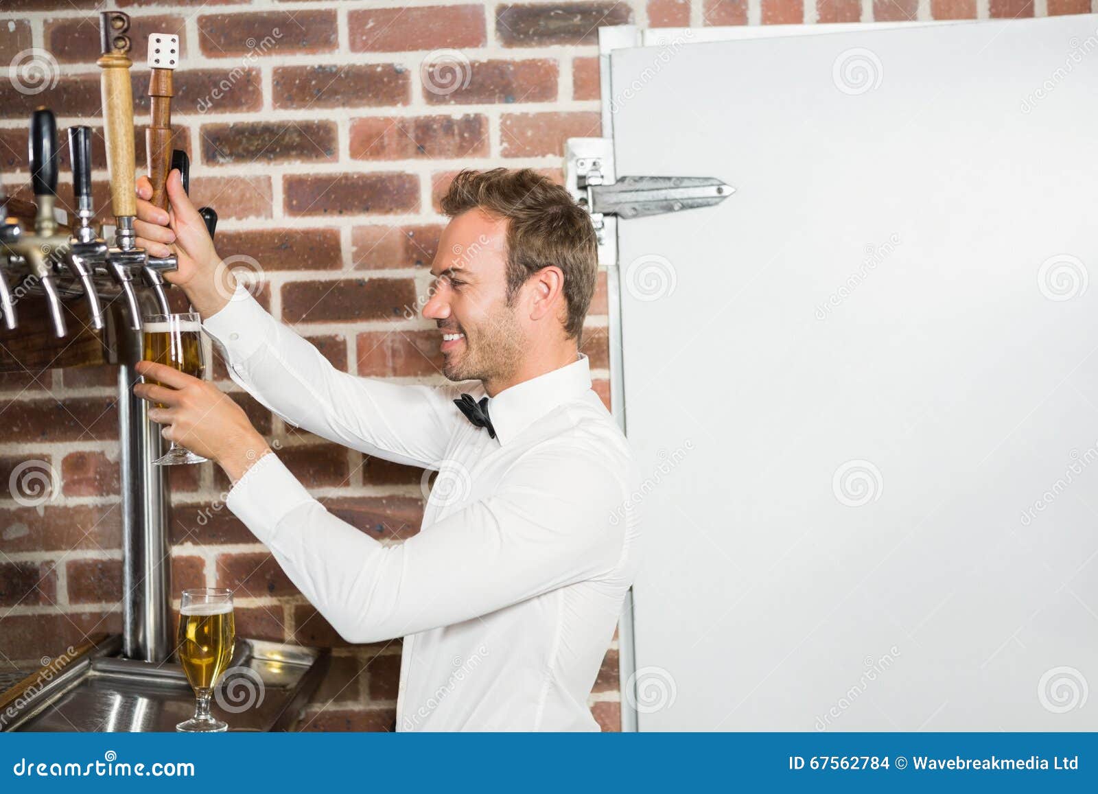 Handsome Bar Tender Pouring a Pint Stock Photo - Image of serious ...