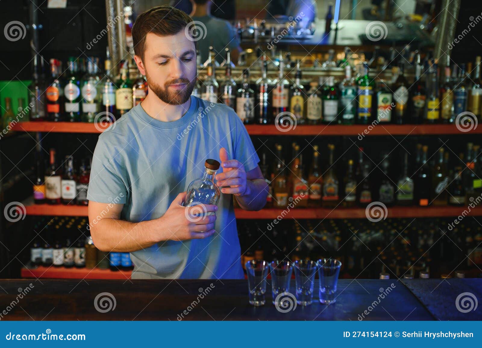 Handsome Bar Tender Standing Behind His Counter in a Pub Stock Photo ...