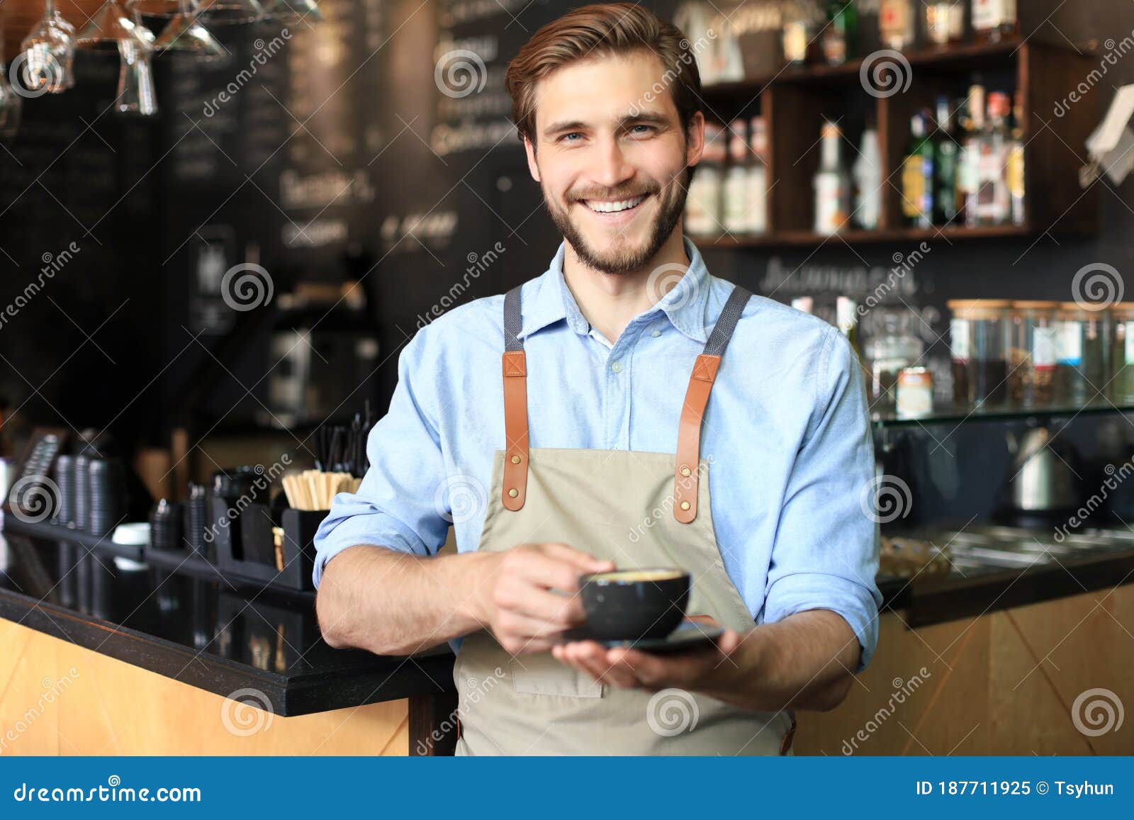 Handsome Barista Offering a Cup of Coffee To Camera at the Coffee Shop ... Handsome Barista Offering a Cup of Coffee To Camera at the Coffee Shop ...