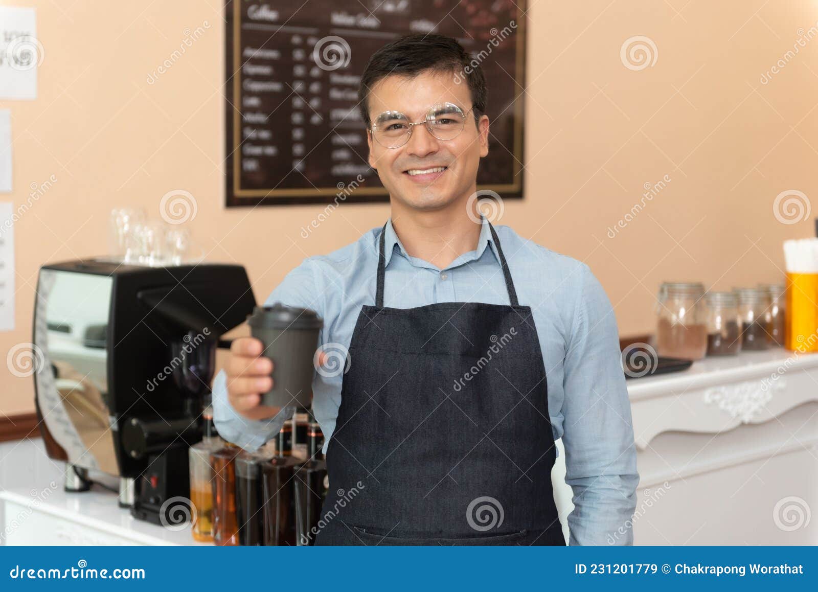 Handsome Barista Offering a Cup of Coffee To Camera at the Coffee Shop ... Handsome Barista Offering a Cup of Coffee To Camera at the Coffee Shop ...
