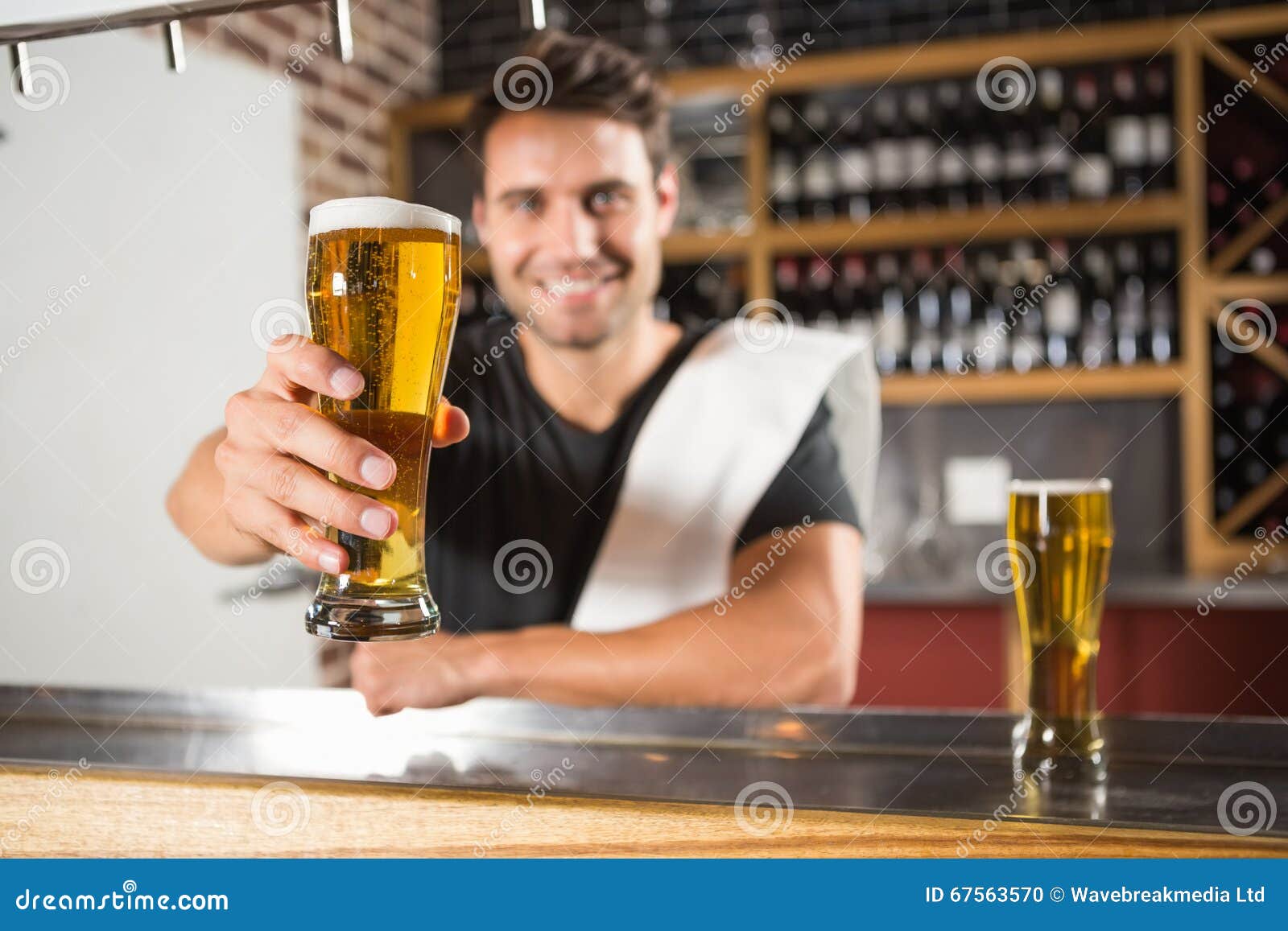 Handsome Barman Holding a Pint of Beer Stock Photo - Image of glass ...