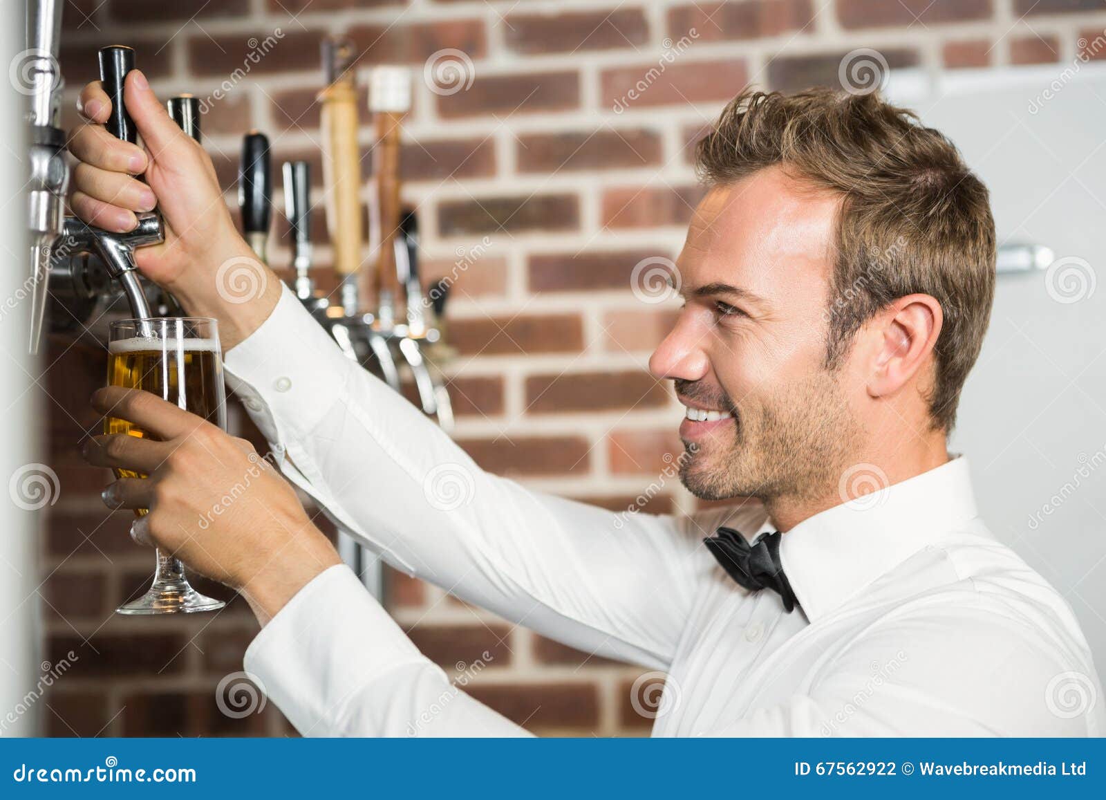 Handsome Barman Pouring a Pint of Beer Stock Photo - Image of happy ...