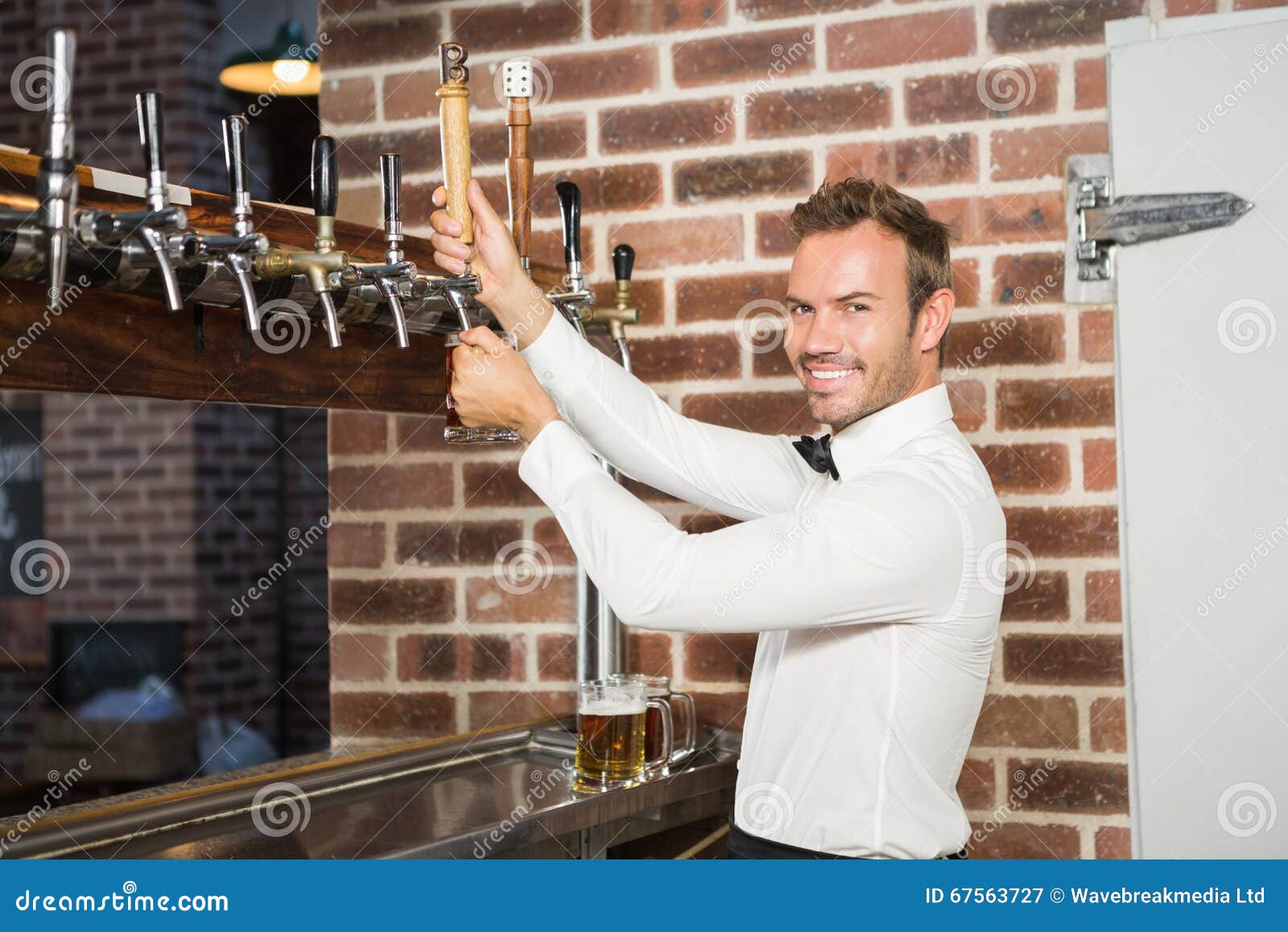 Handsome Barman Pouring a Pint of Beer Stock Image - Image of ...