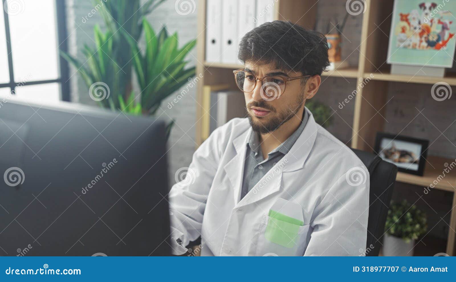 Handsome Bearded Arab Man in a Lab Coat Working on a Computer in a ...