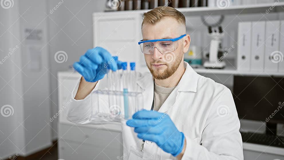 Handsome Bearded Man in a Lab Analyzing Test Tubes Indoors Stock Photo ...