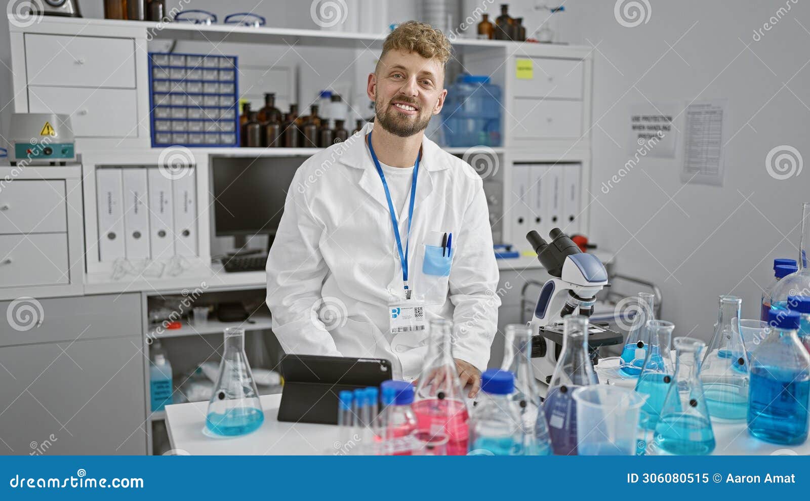 Handsome Bearded Scientist with Blue Eyes in Lab Coat Researching in a ...