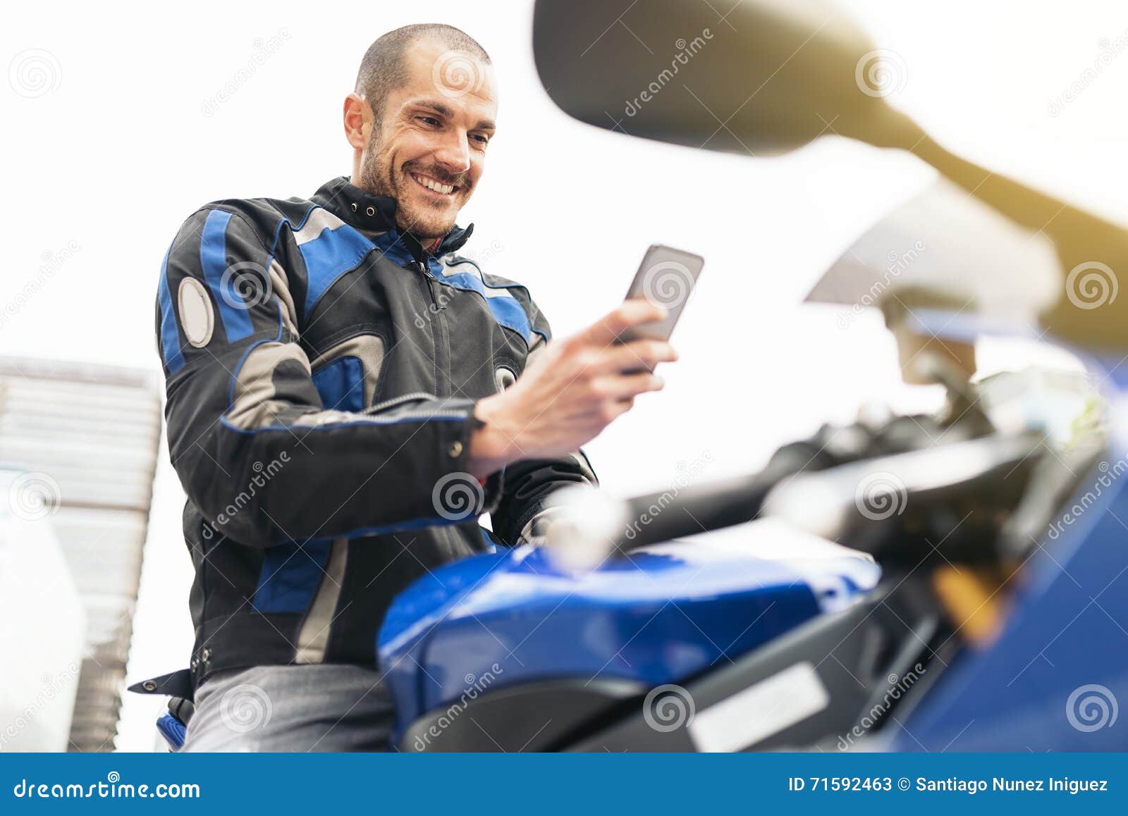 Handsome Biker Using Mobile Phone. Stock Image - Image of talking ...