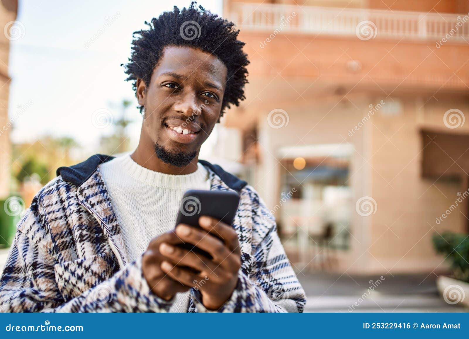 Handsome Black Man with Afro Hair Smiling Happy Outdoors Using ...